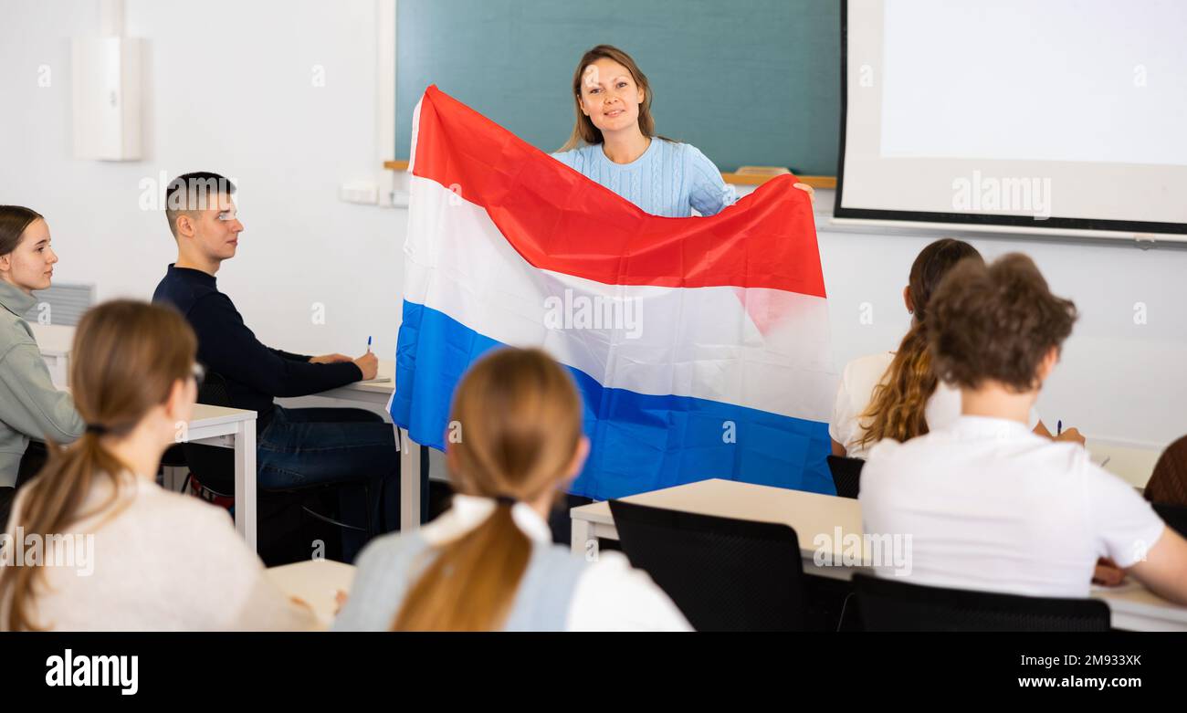 Female professor shows students flag of Netherlands Stock Photo - Alamy