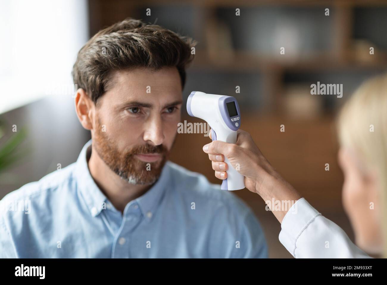 Doctor Lady With Infrared Thermometer Checking Body Temperature For ...