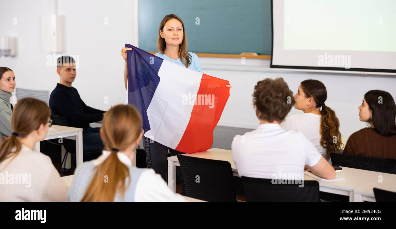 Geography lesson in school class - teacher talks about France, holding ...