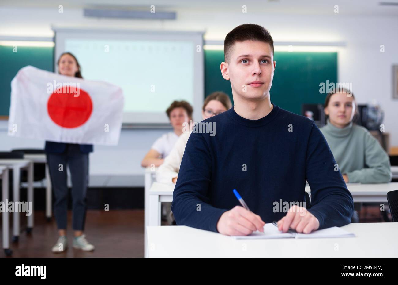 Young boy student studying diligently at school Stock Photo - Alamy