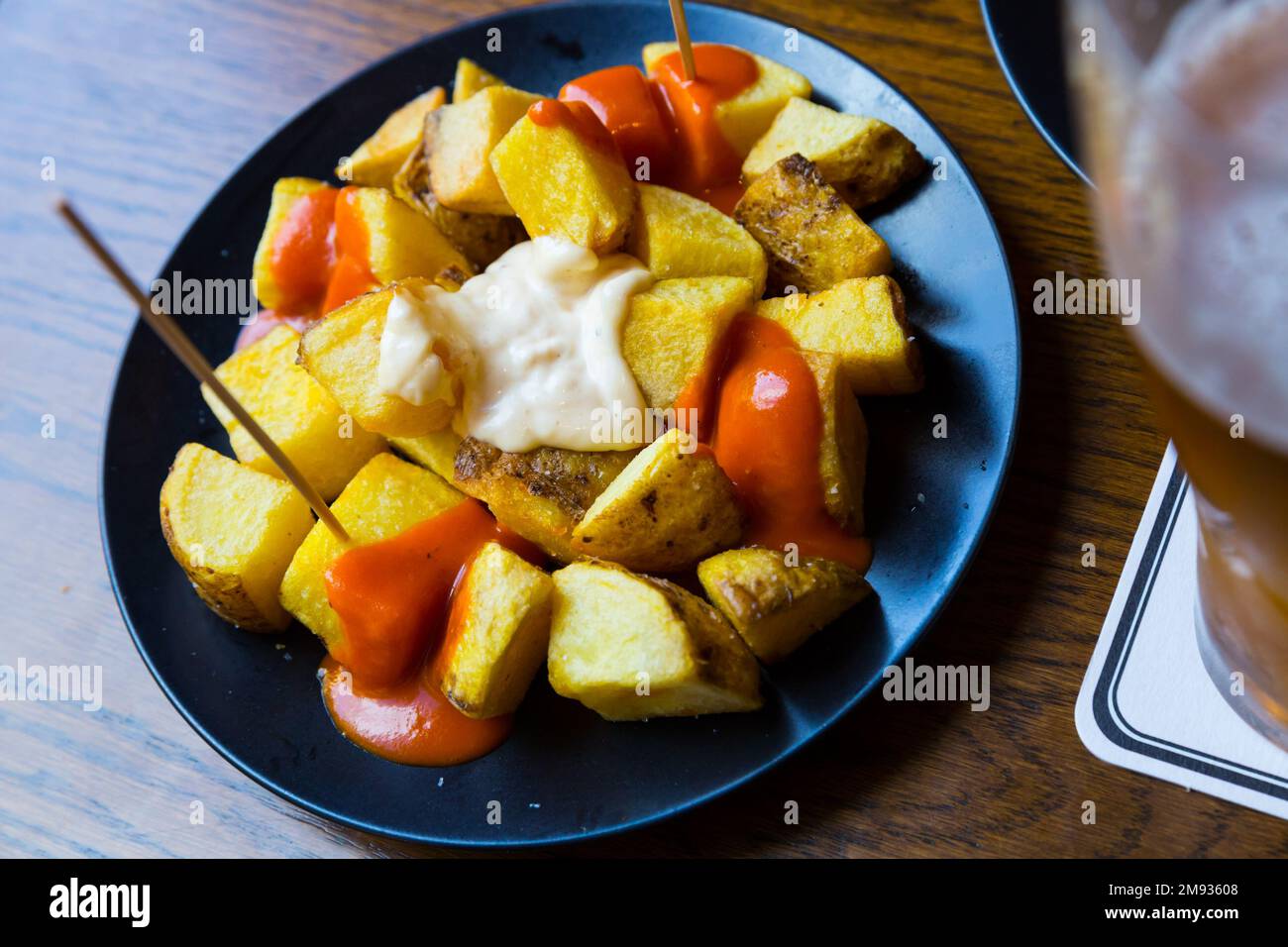 Top view of Patatas bravas, traditional Spanish dish of fried potatoes ...