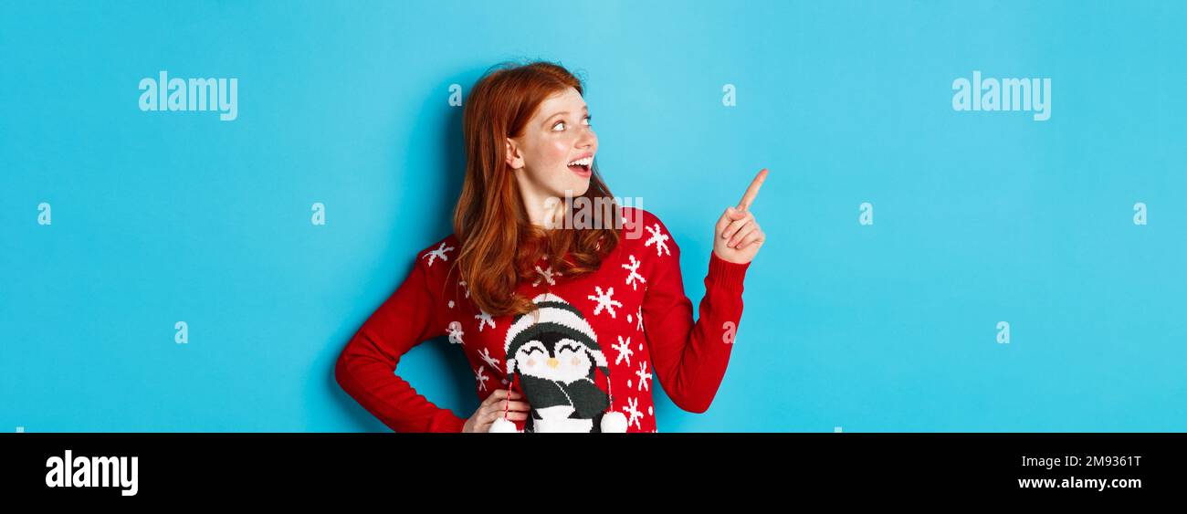 Winter holidays and Christmas Eve concept. Happy and cute redhead girl ...