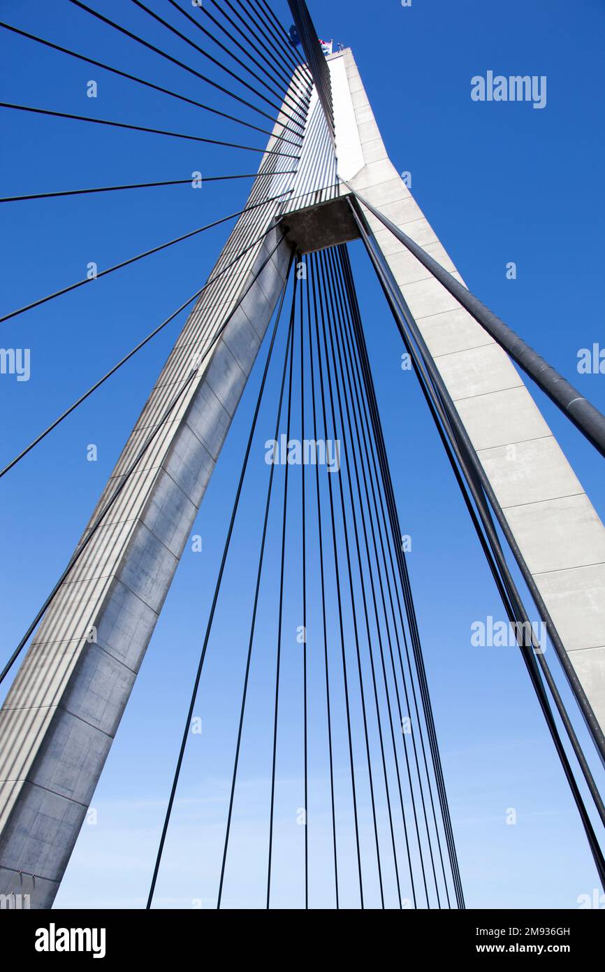 The abstract view of Anzac cable-stayed bridge tower with a flag on a ...