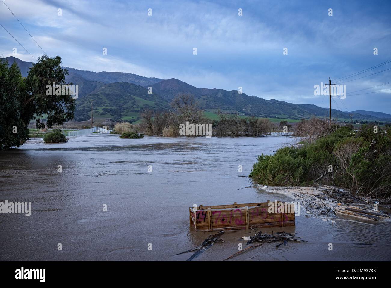 Salinas River overflowing its banks and flooding into agriculture fields after a series of ...