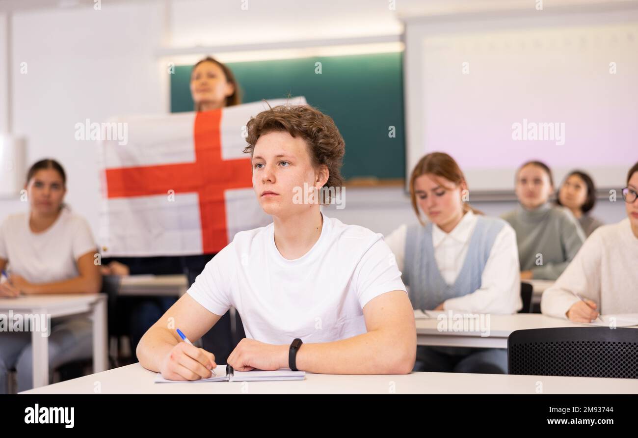 Teacher stands behind students with flag of England Stock Photo - Alamy