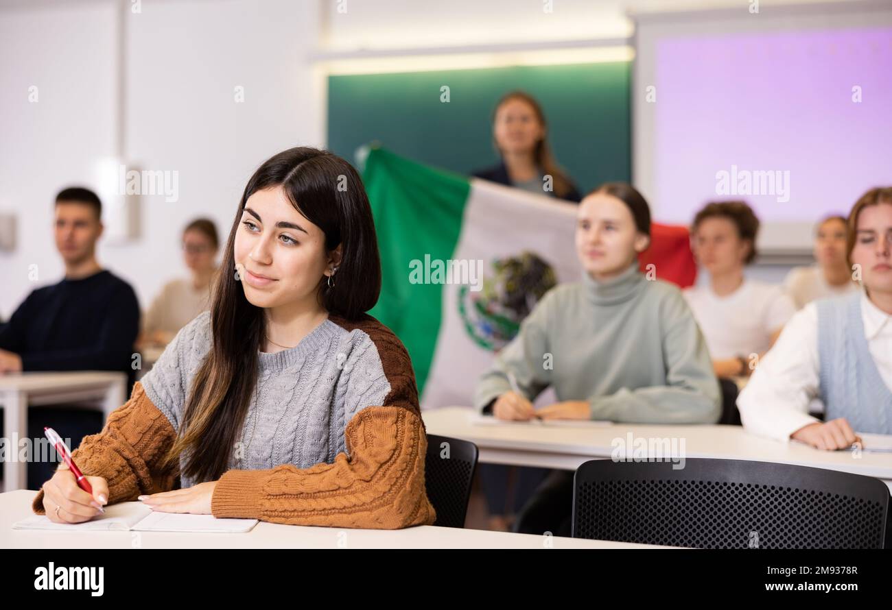 Teacher stands behind students with Mexican flag Stock Photo - Alamy