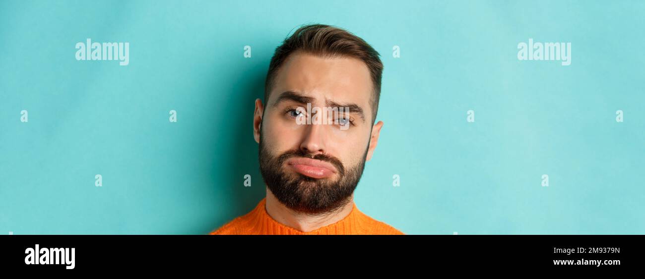 Headshot of sad and gloomy man complaining, pouting and frowning ...