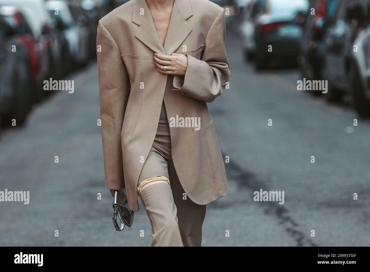 Milan, Italy - February 26, 2022: Woman in stylish beige suit adjusting ...