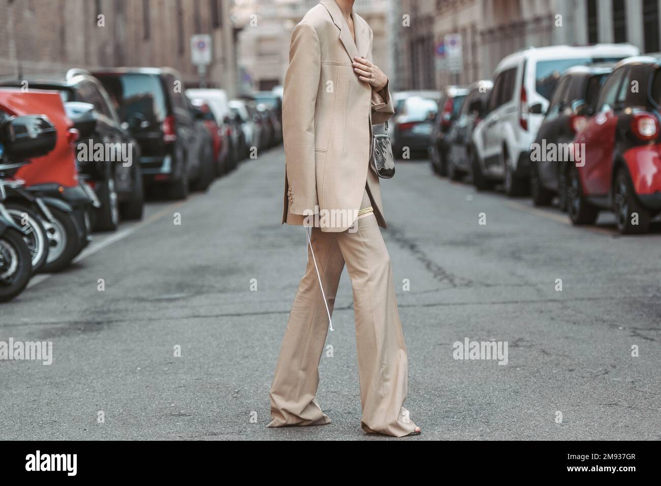 Milan, Italy - February 26, 2022: Woman in stylish beige suit adjusting ...