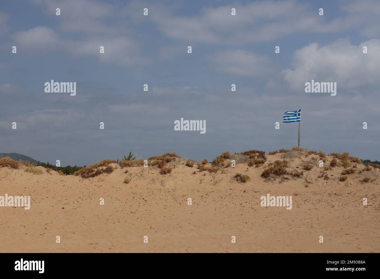 Greek flag on picturesque beach, flying flag on dune Stock Photo - Alamy