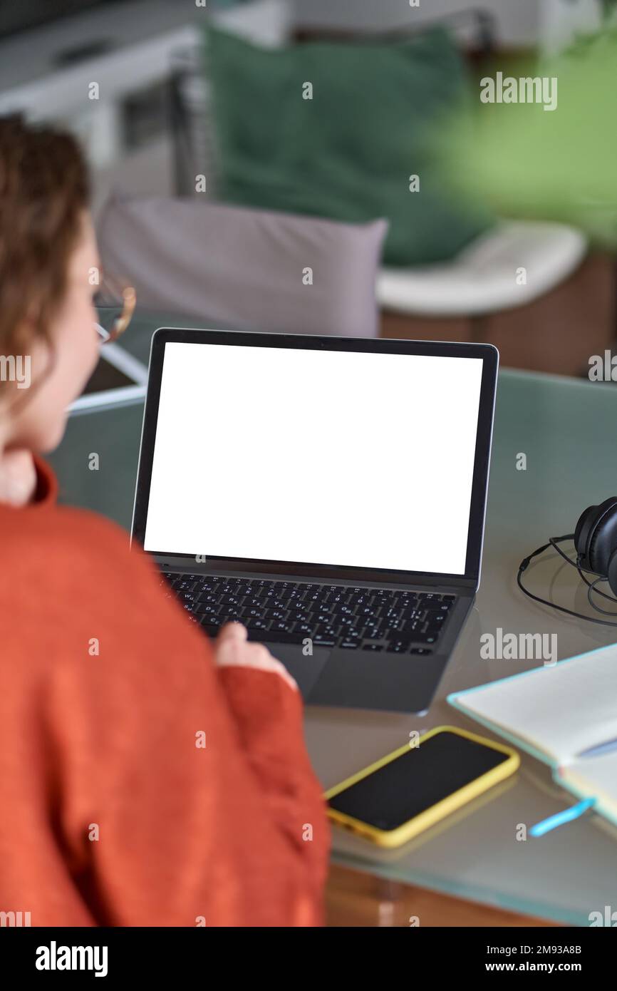Woman elearning looking at mock up screen using laptop, over shoulder, vertical Stock Photo - Alamy