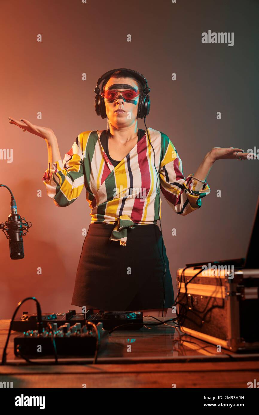 DJ woman showing i dont know sign in studio, acting clueless and unsure ...