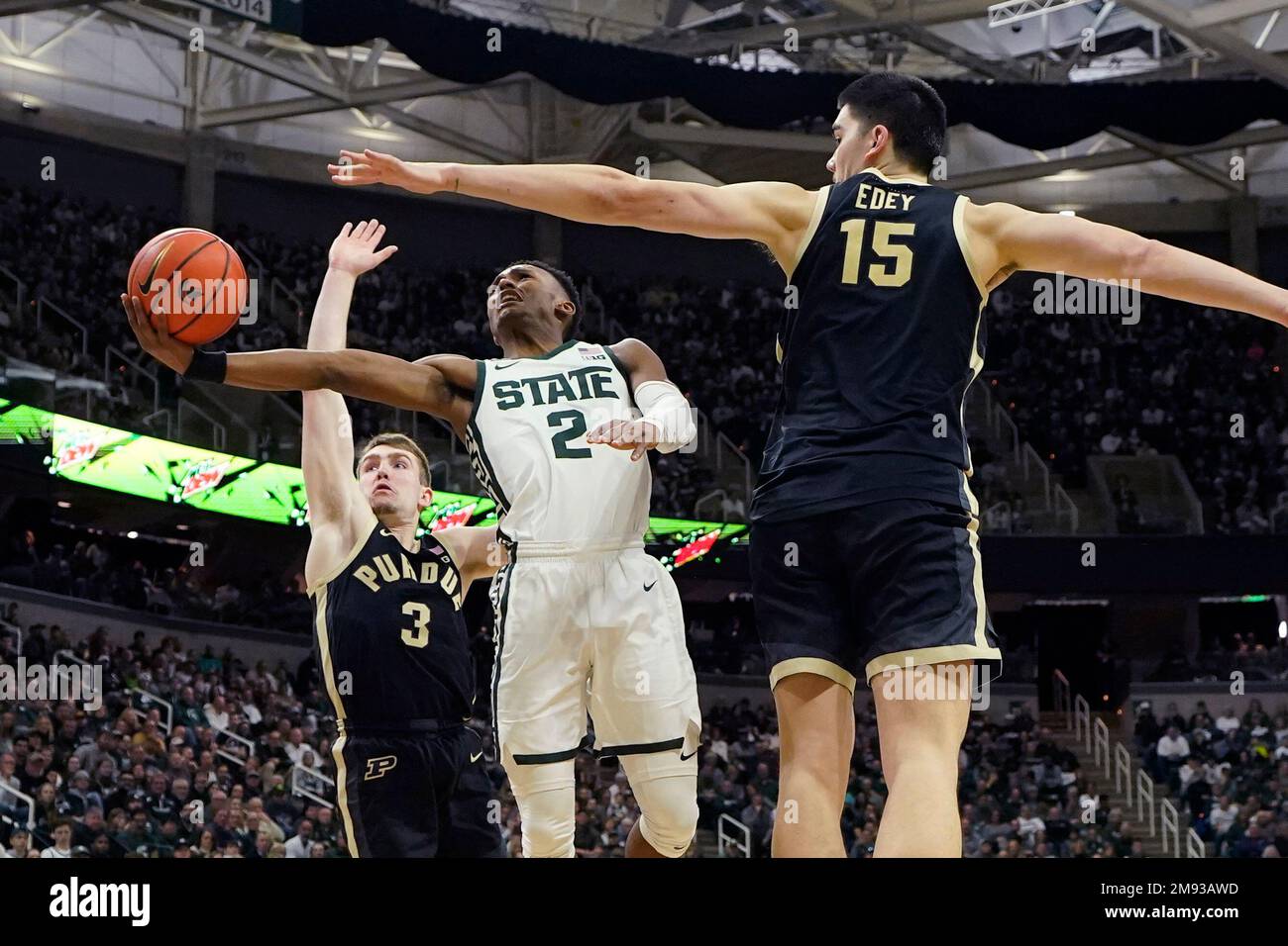 Michigan State guard Tyson Walker (2) attempts a layup as Purdue center ...