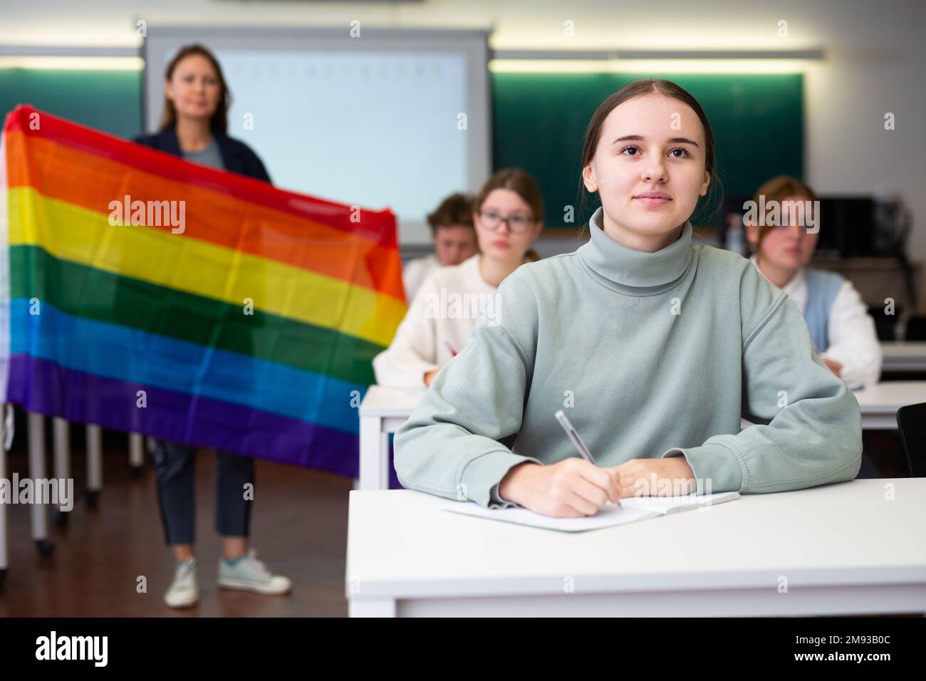 Teacher explaining meaning of LGBT flag to students Stock Photo - Alamy