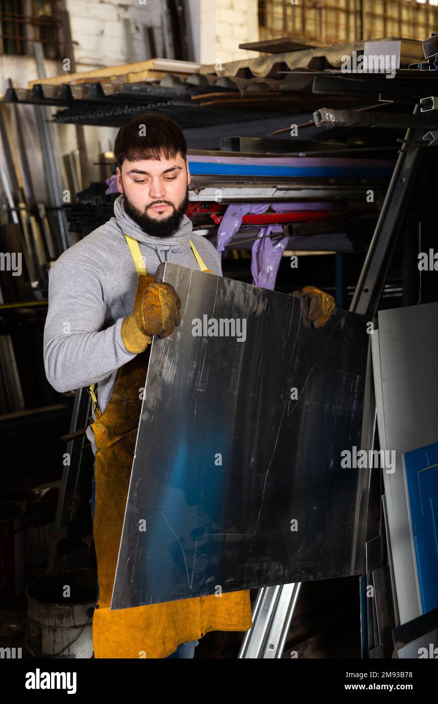 Professional worker works in factory production warehouse Stock Photo ...