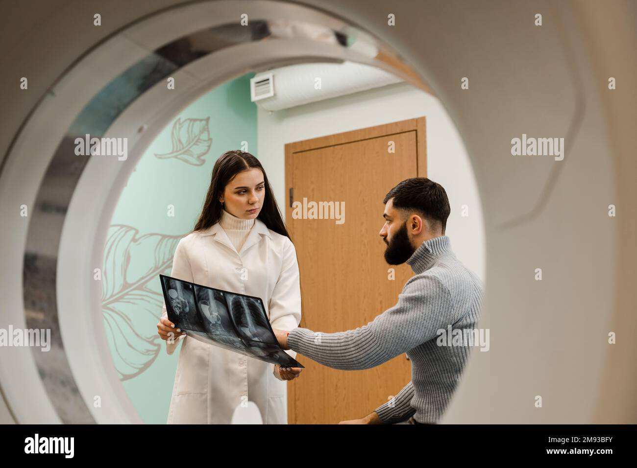 CT Doctor consulting patient and showing chest x-ray to patient in ...