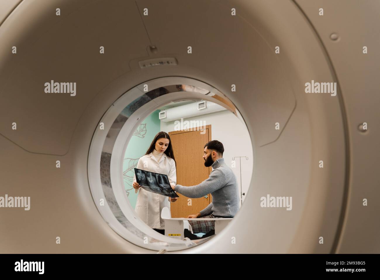 CT Doctor consulting patient and showing chest x-ray to patient in ...