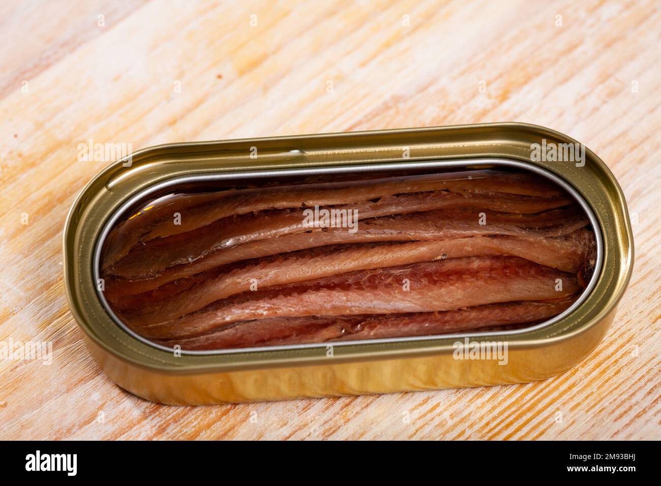 Close-up of canned anchovy fillet in oil on wooden surface Stock Photo ...