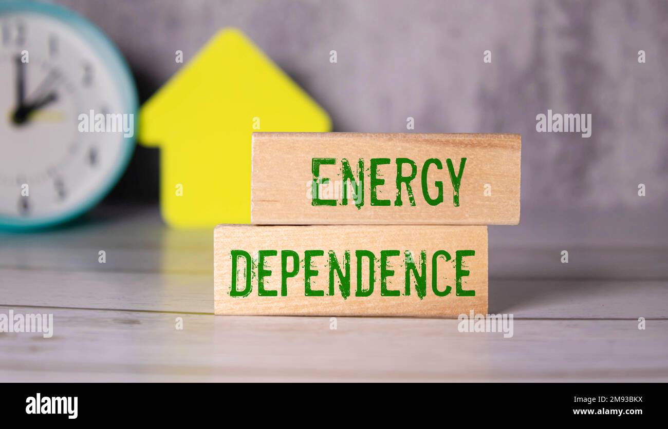 text Energy Dependence on wooden block, concept Stock Photo - Alamy