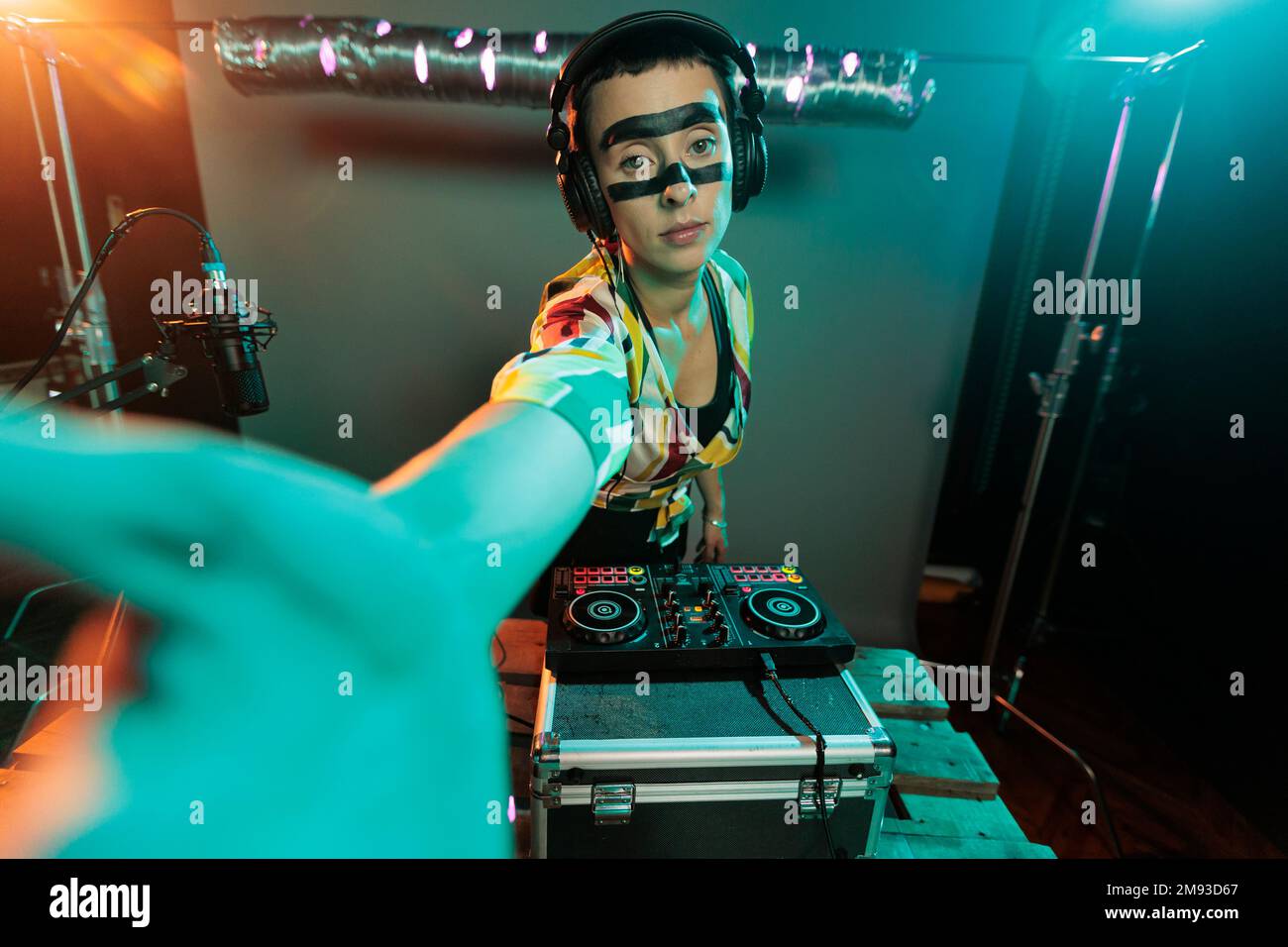 Disc jockey using turntables to mix music, performing techno beats and ...