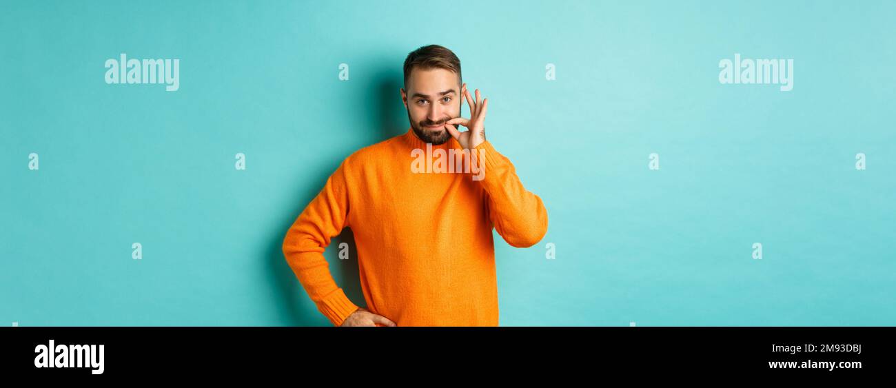 Handsome bearded man promise keep mouth shut, seal lips, lock mouth on ...