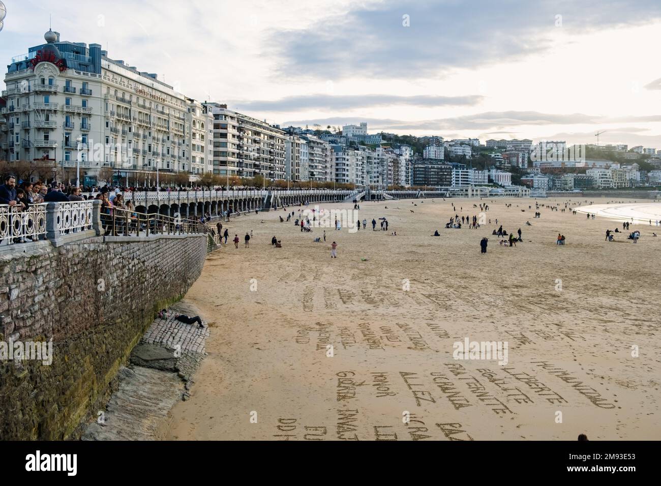 San Sebastian, Spain - December 28, 2022: People walking on the sand of ...