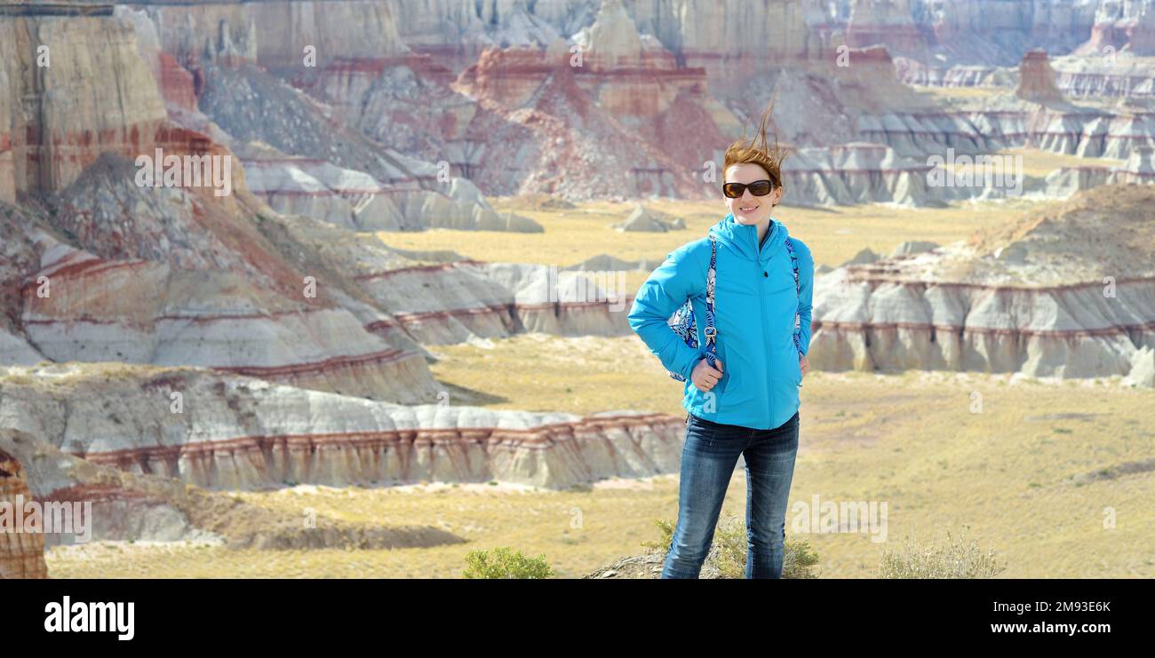 Young female hiker admiring views of stunning striped sandstone ...