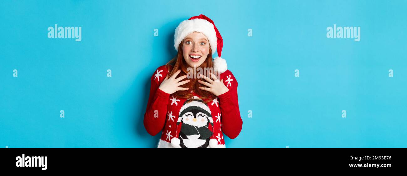 Happy holidays and Christmas concept. Surprised redhead girl receiving ...