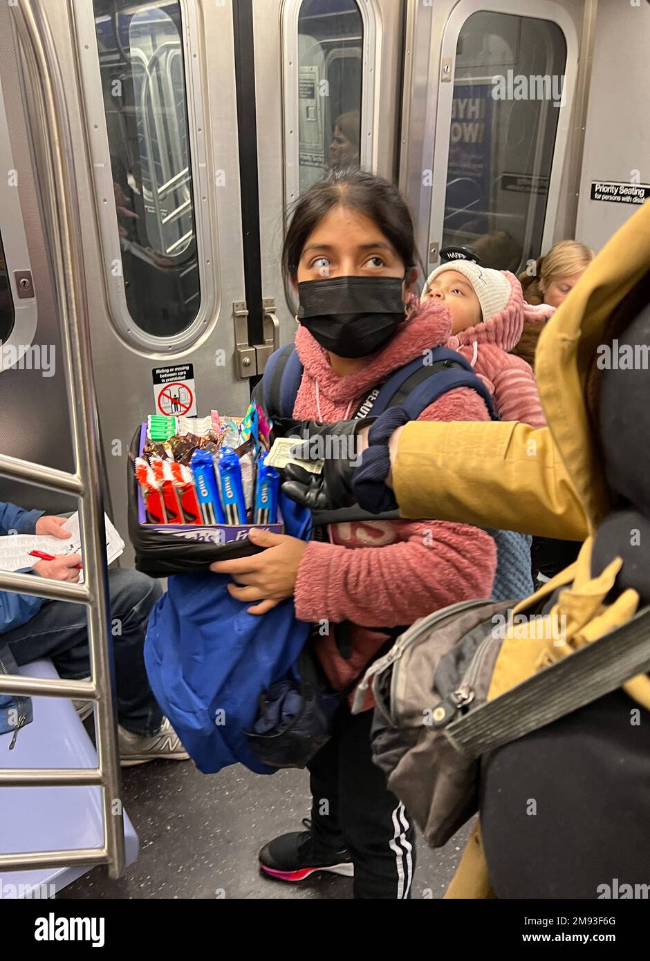 Undocumented Mexican mom sells candy with her baby on her back on a New ...