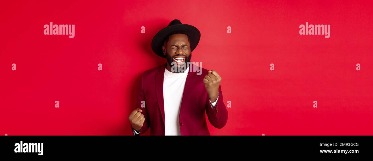 Lucky african american man celebrating victory, winning and rejoicing ...