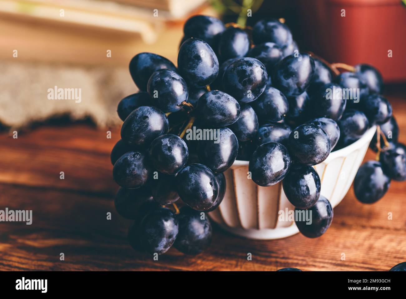 Close Up of Black Grapes in a Vintage Bowl Stock Photo - Alamy