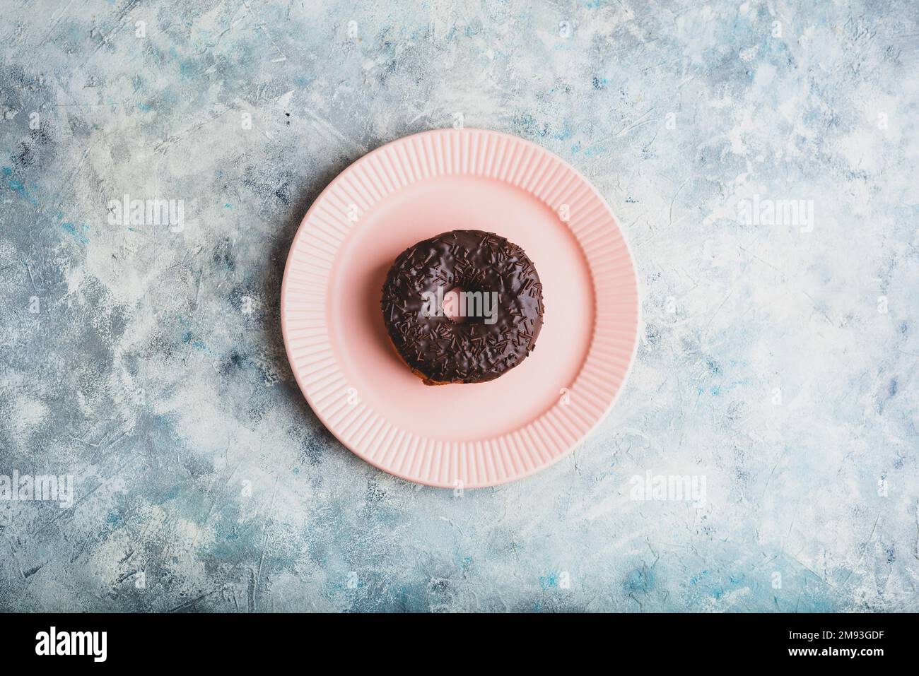 Chocolate Donut on Pink Plate. View from Above Stock Photo - Alamy