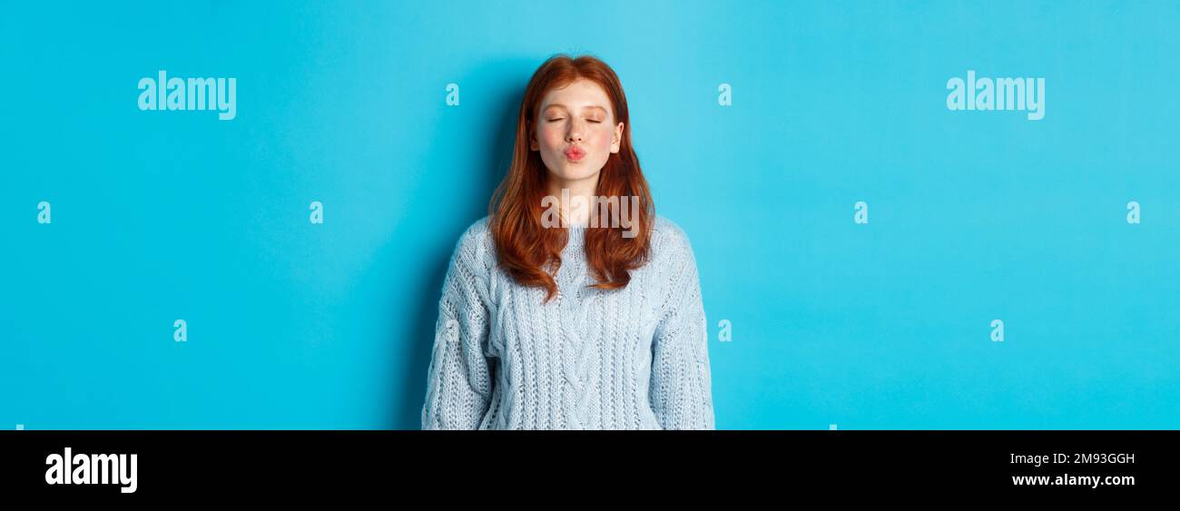 Cute redhead teen girl waiting for kiss, pucker lips and close eyes ...