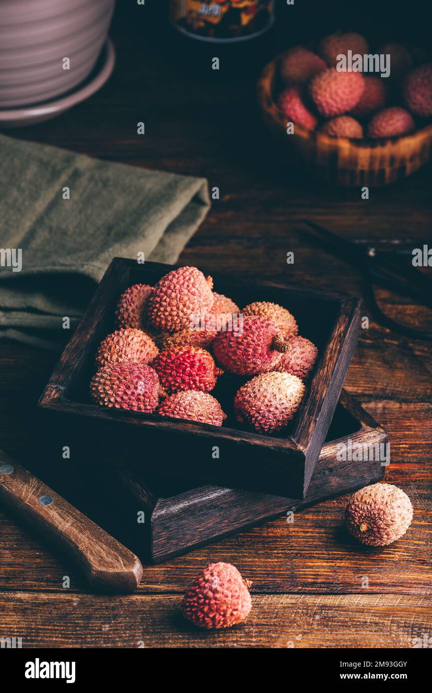 Small Box of Fresh Lychees on Wooden Table Stock Photo - Alamy