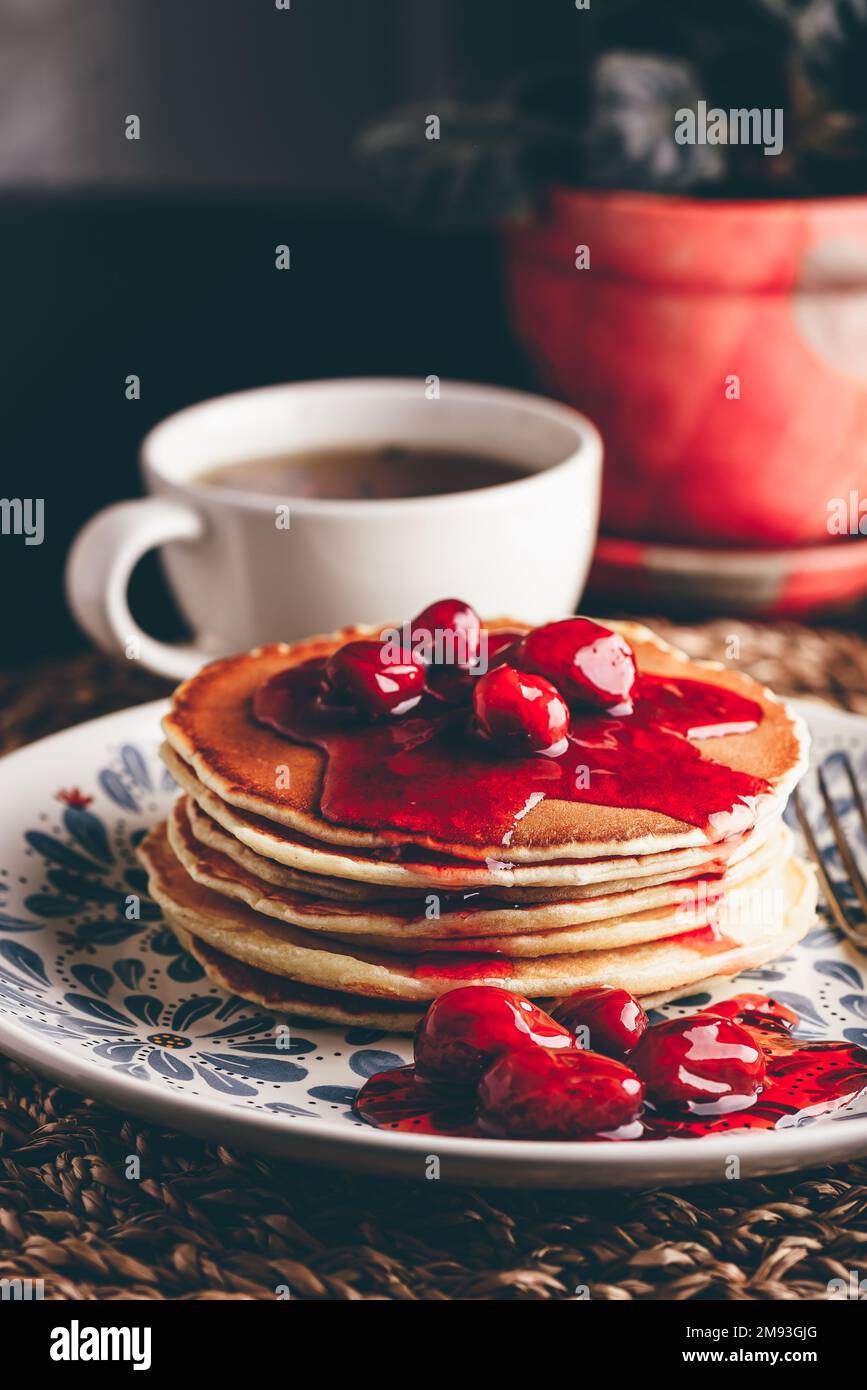 Stack of pancakes with dogberry jam on white plate with ornate Stock ...