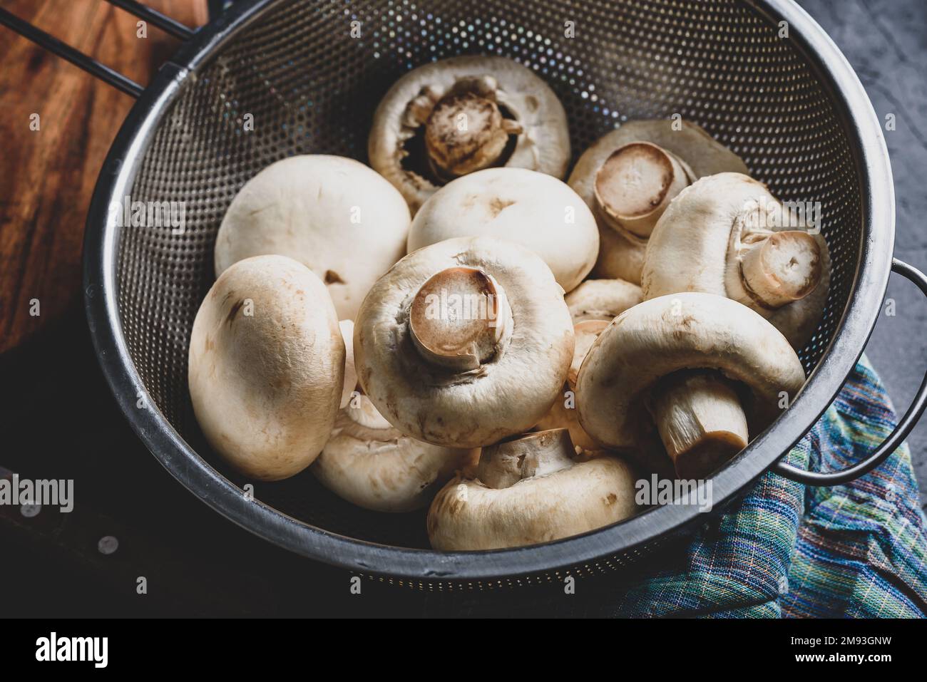 Fresh white button mushrooms in metal colander Stock Photo - Alamy
