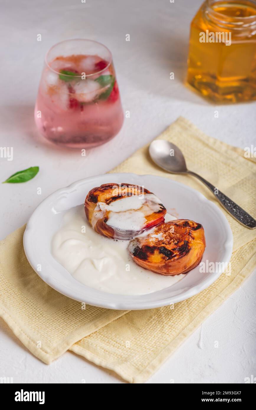 Served Grilled Peaches with Honey and Whipped Heavy Cream on White ...