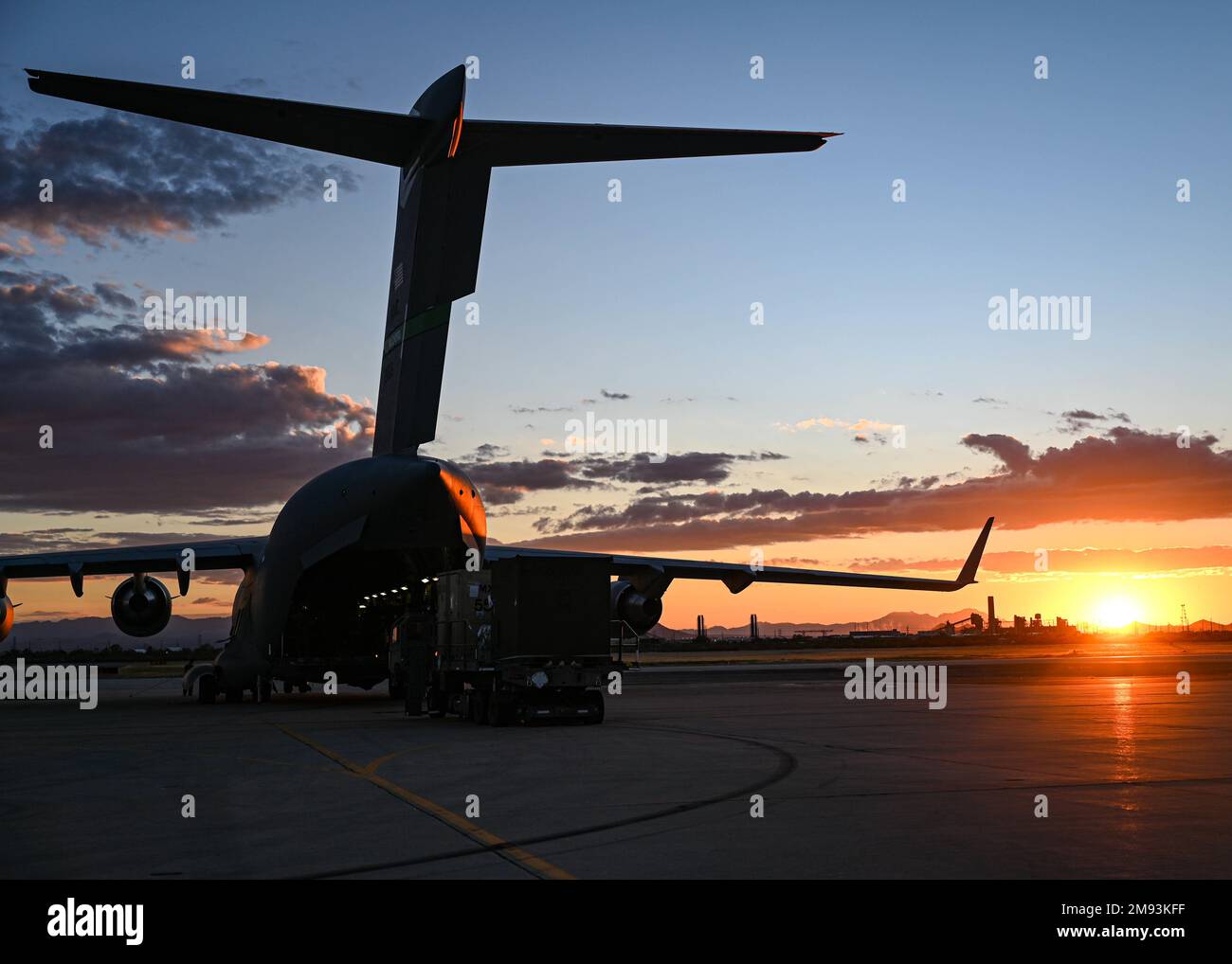Airmen unload deployment equipment from a C-17 Globemaster III assigned ...