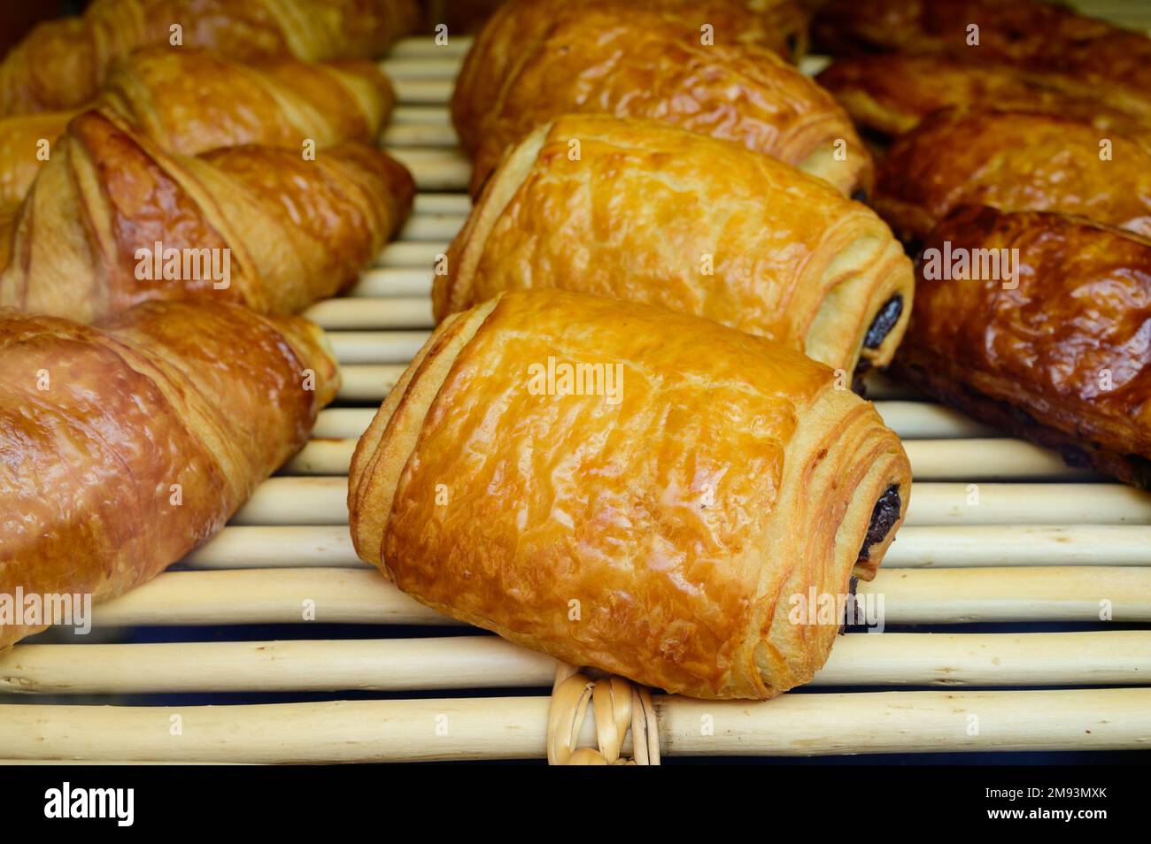 French bakery, fresh baked sweet buns and rolls on display in small ...