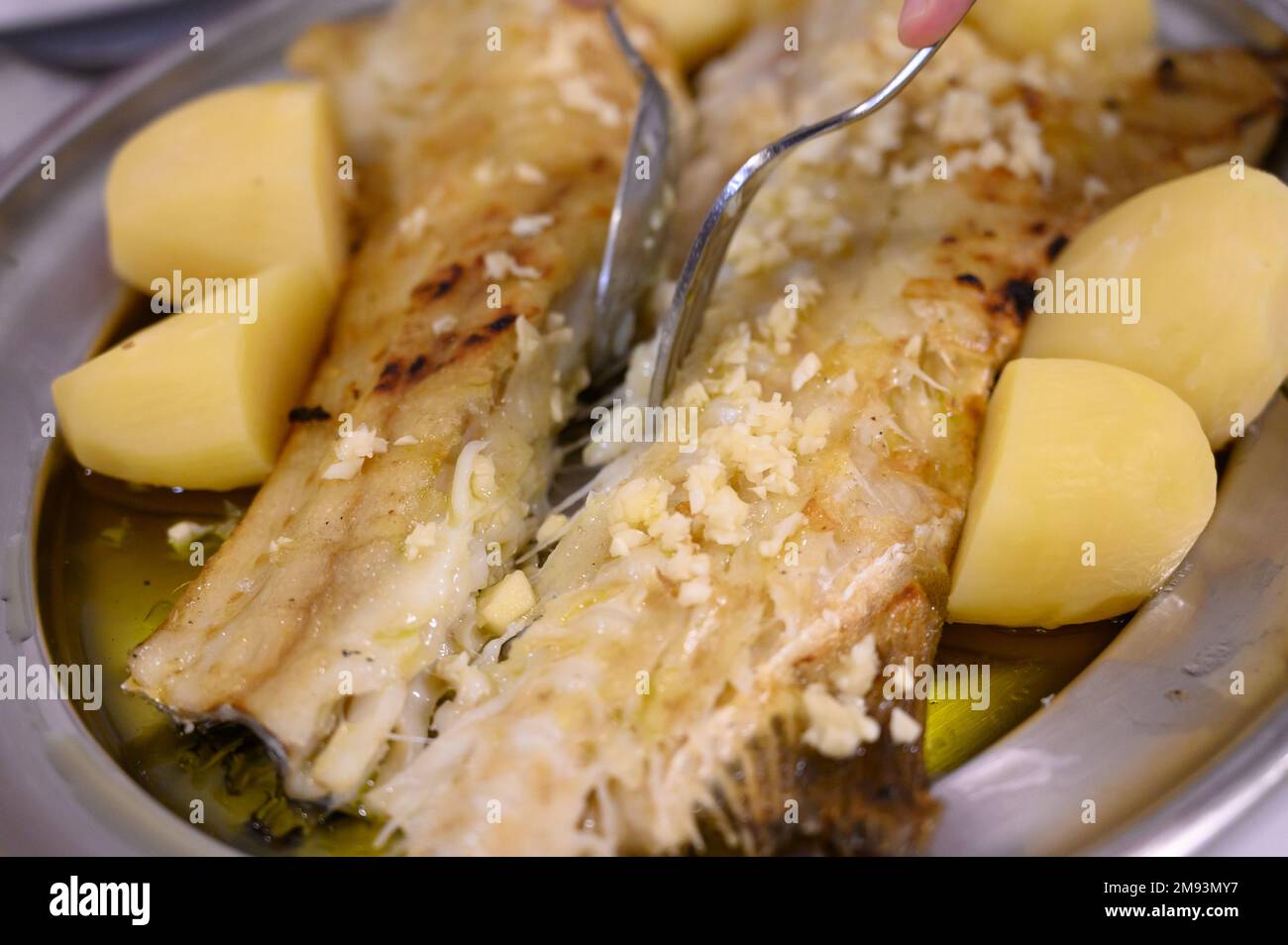 Grilled fillet of white codfish bacalhau served with potatos in fish ...