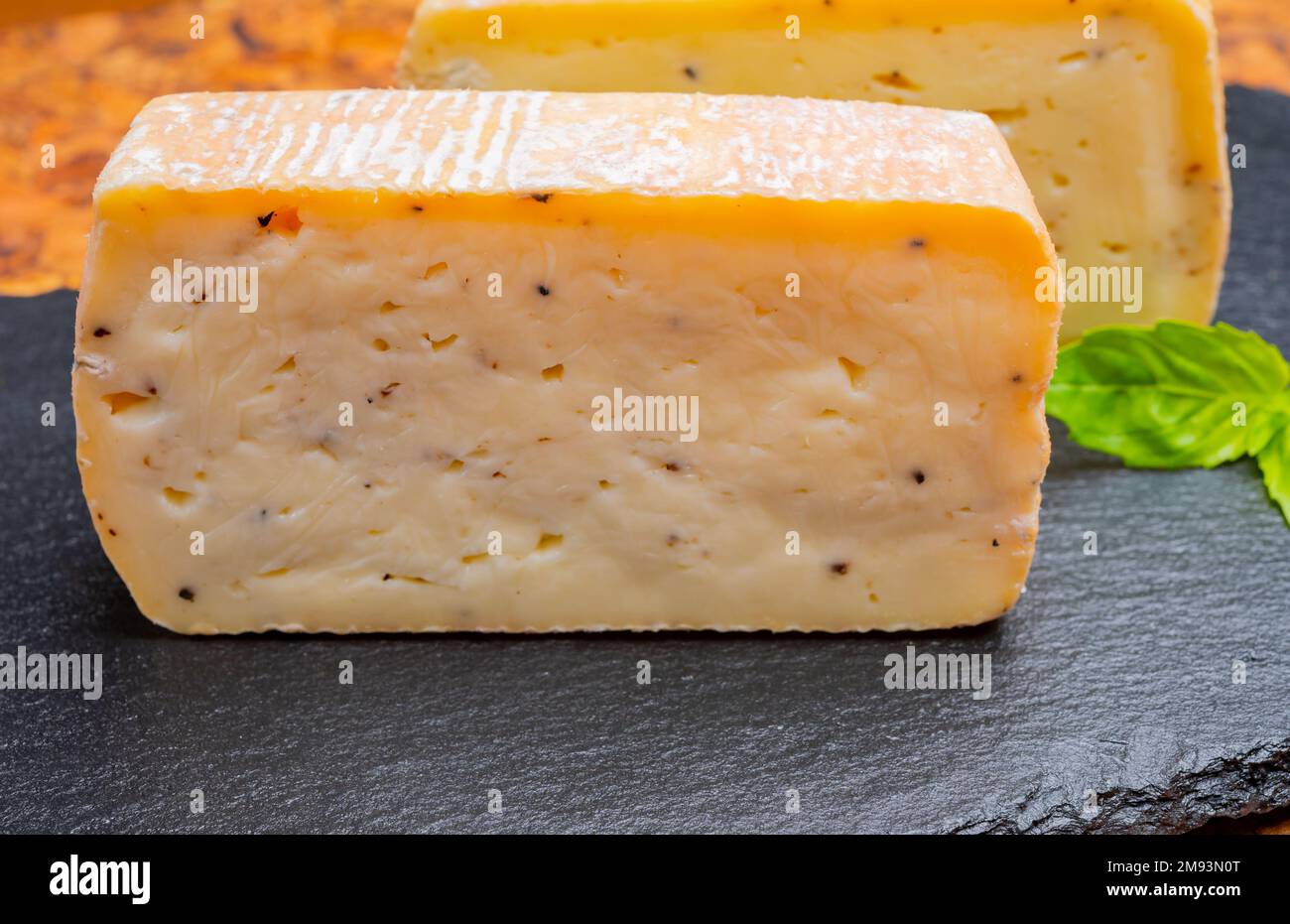 Italian cheese collection, yellow taleggio cheese with black truffles ...