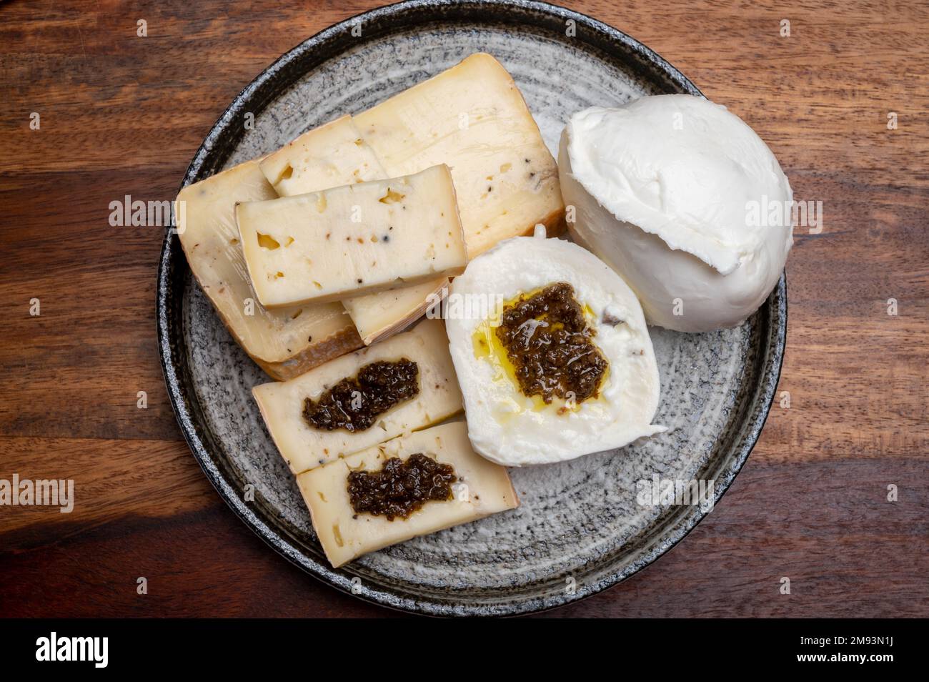 Italian cheese collection, yellow taleggio cheese and white mozzarella ...