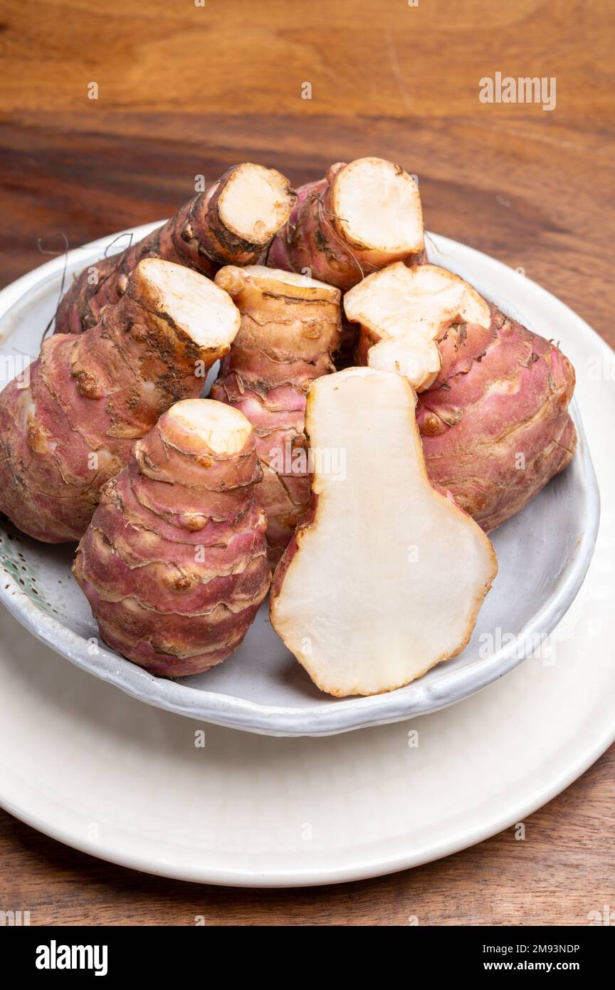 Group of fresh uncooked topinambur or Jerusalem artichoke roots close ...
