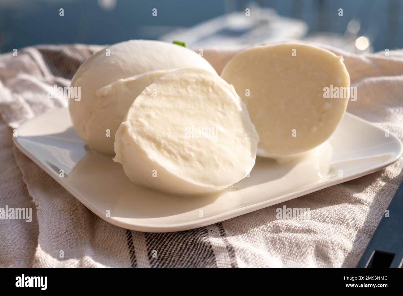 Tasting of white soft italian balls mozzarella cheese made from buffalo ...