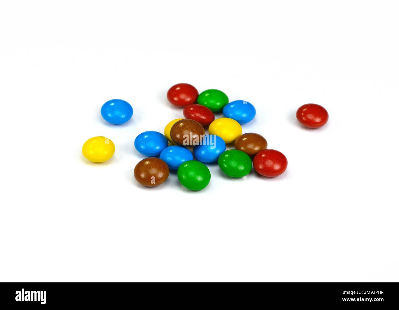 Round candies on a white background, scattered candies. Colorful round ...