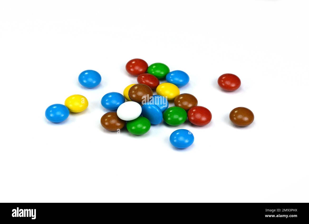 Round candies on a white background, scattered candies. Colorful round ...