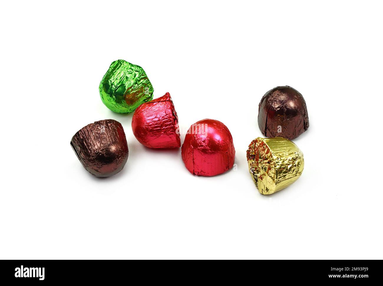 Chocolates in a multi-colored foil isolated on white background Stock ...