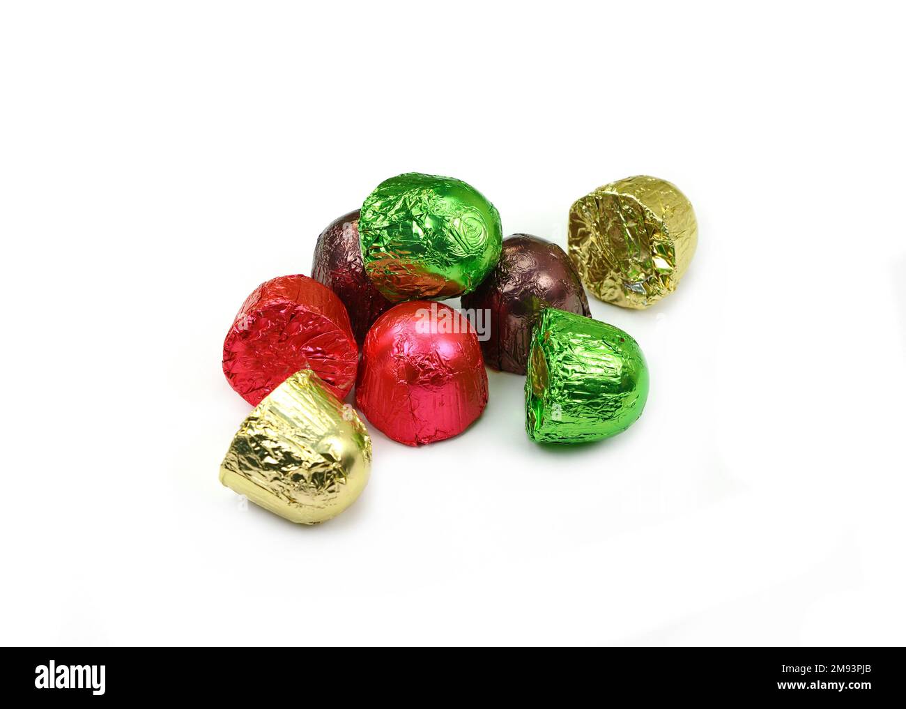 Chocolates in a multi-colored foil isolated on white background Stock ...