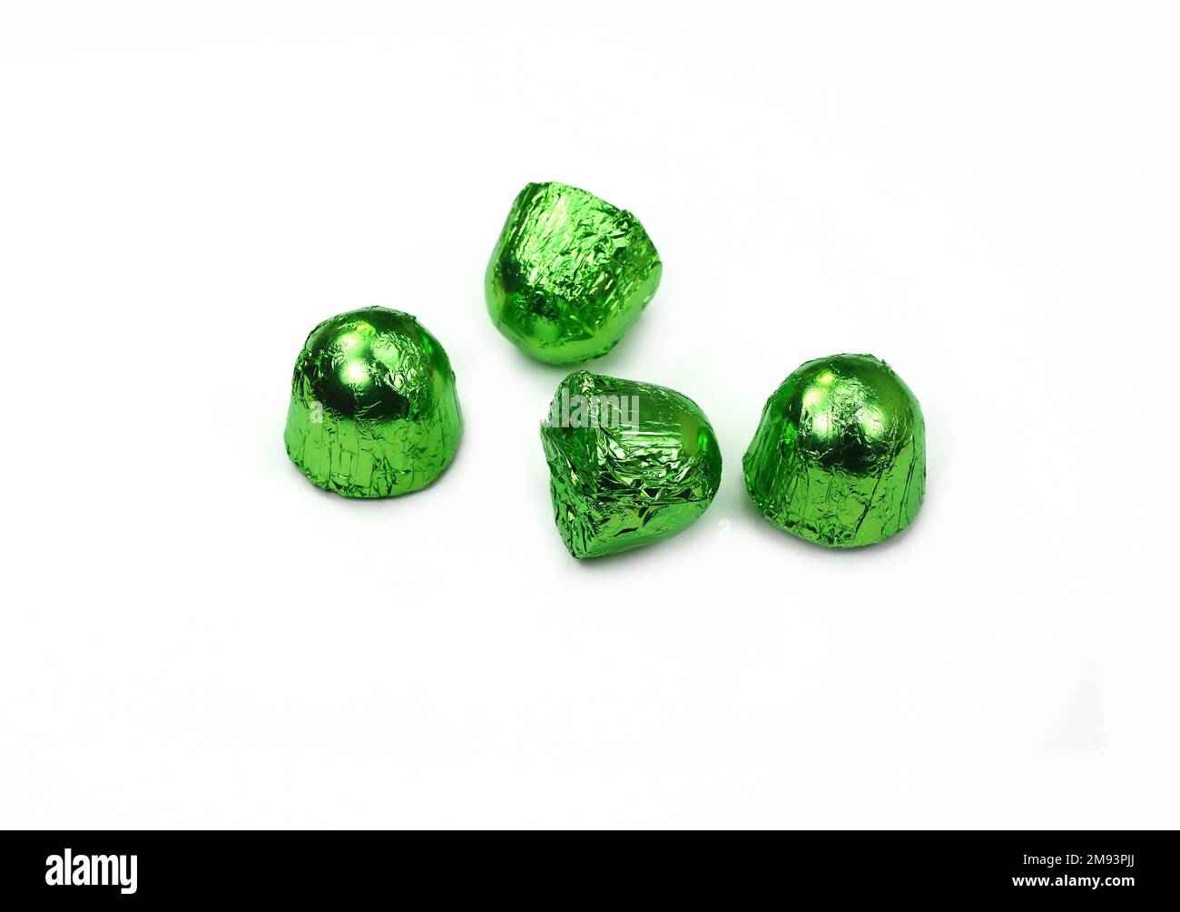 Chocolates in a green foil isolated on white background Stock Photo - Alamy