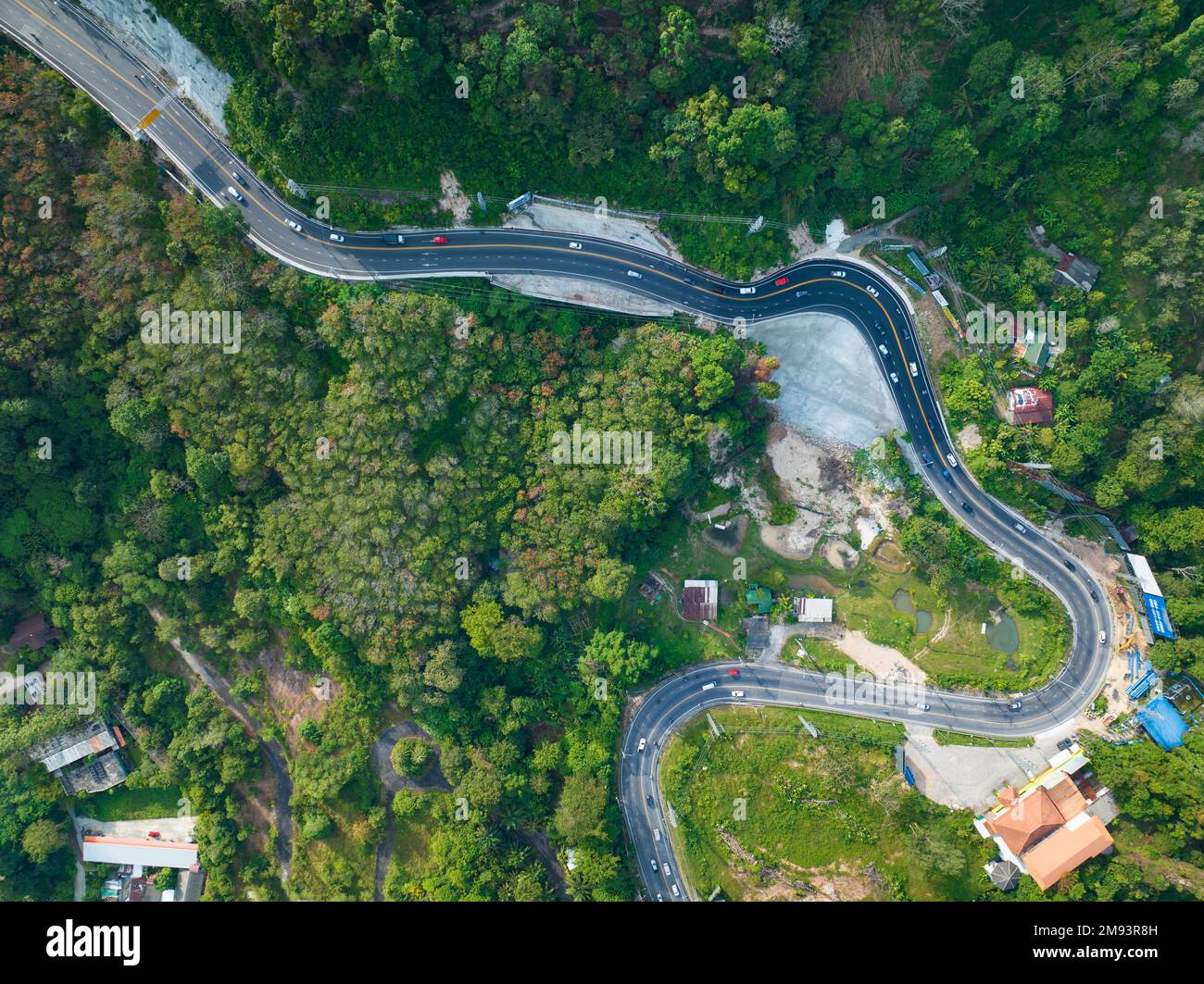 Aerial view top down drone shot above the winding mountain road between ...